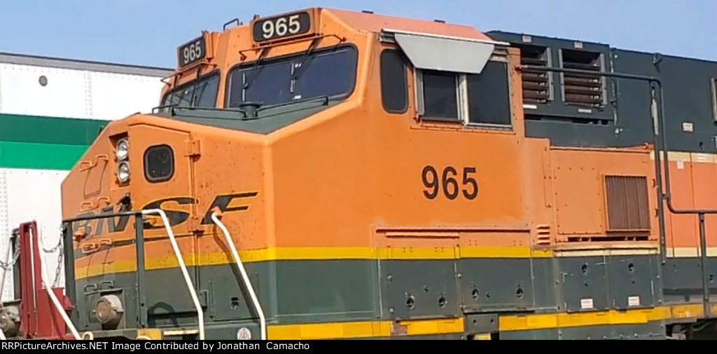 BNSF 965 with H3 Swoosh logo on the nose.